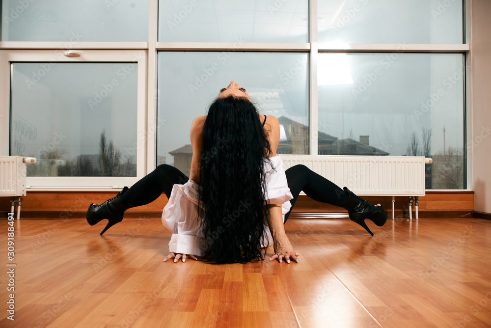Attractive girl with a good figure dancing strip-plastic in the dance ...