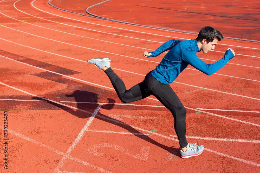 Runner starting his sprint on running track in a stadium . Stock Photo ...