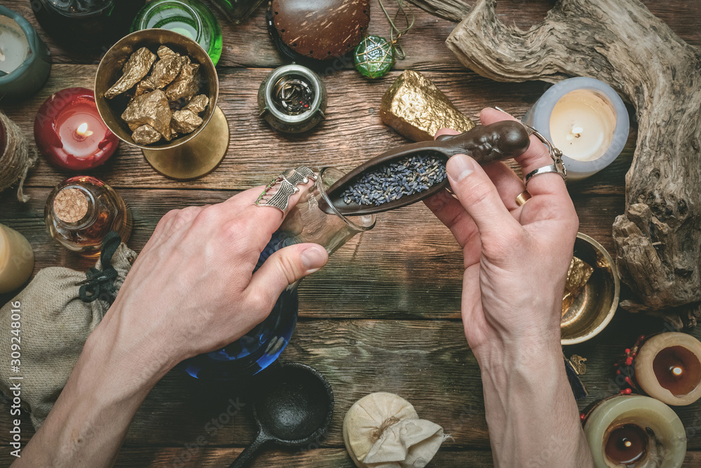 Alchemist producing gold from the stones on his magic table concept ...