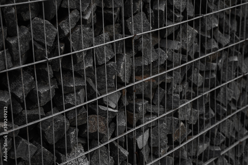 A stone wall that uses metal and stone in harmony. Ecology friendly ...