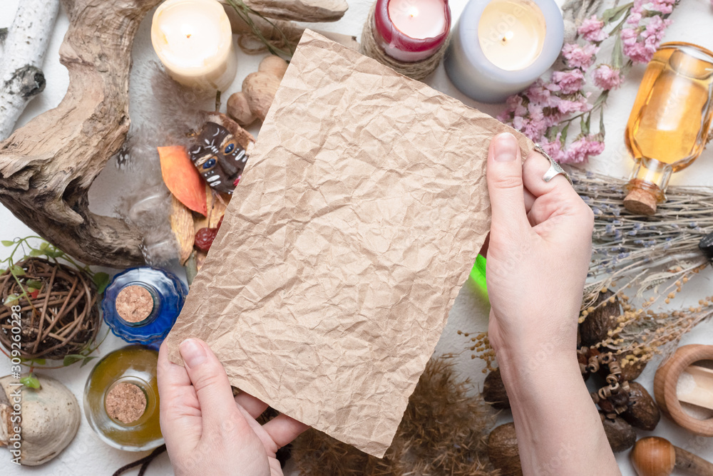 Witch doctor is reading an ancient magic scroll with copy space and ...