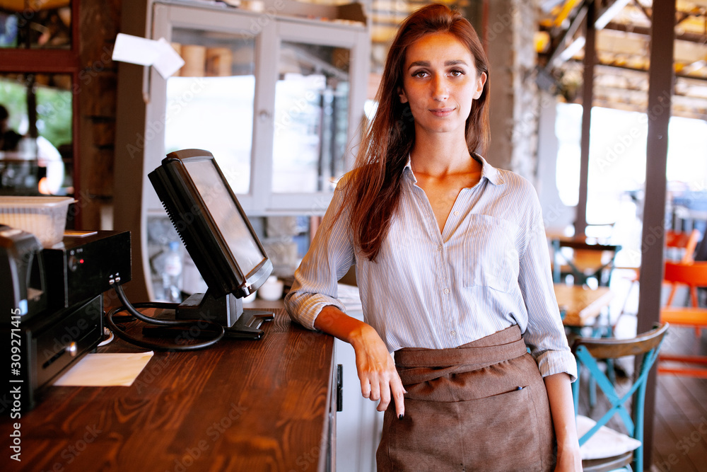 Waist portrait of waitress registrated orders to the payment terminal ...