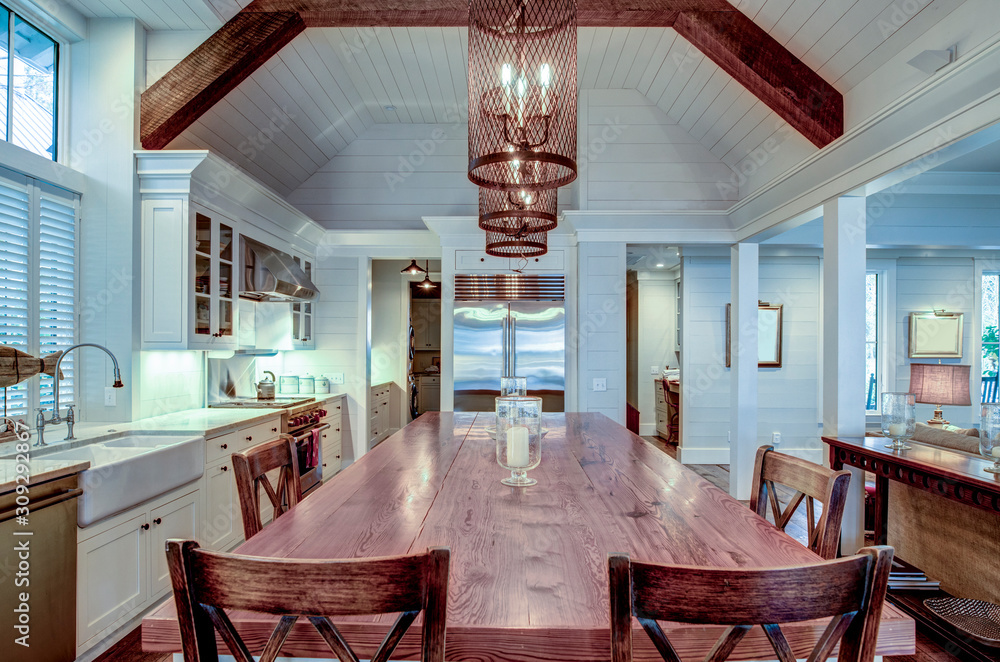 Large luxury kitchen with wood table and high end appliances. Stock ...