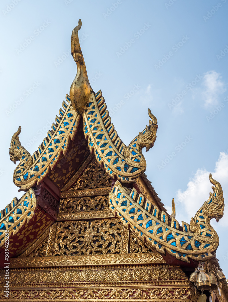 Carved floral pattern in the traditional Thai style on the gable of the ...