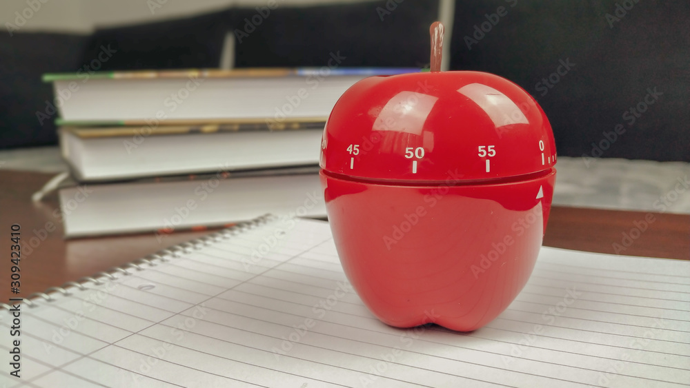 Closeup of pomodoro study technique kitchen timer in shape of a red ...