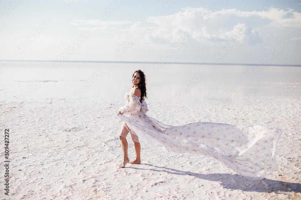 Beautiful woman on a pink lake. Stock Photo | Adobe Stock