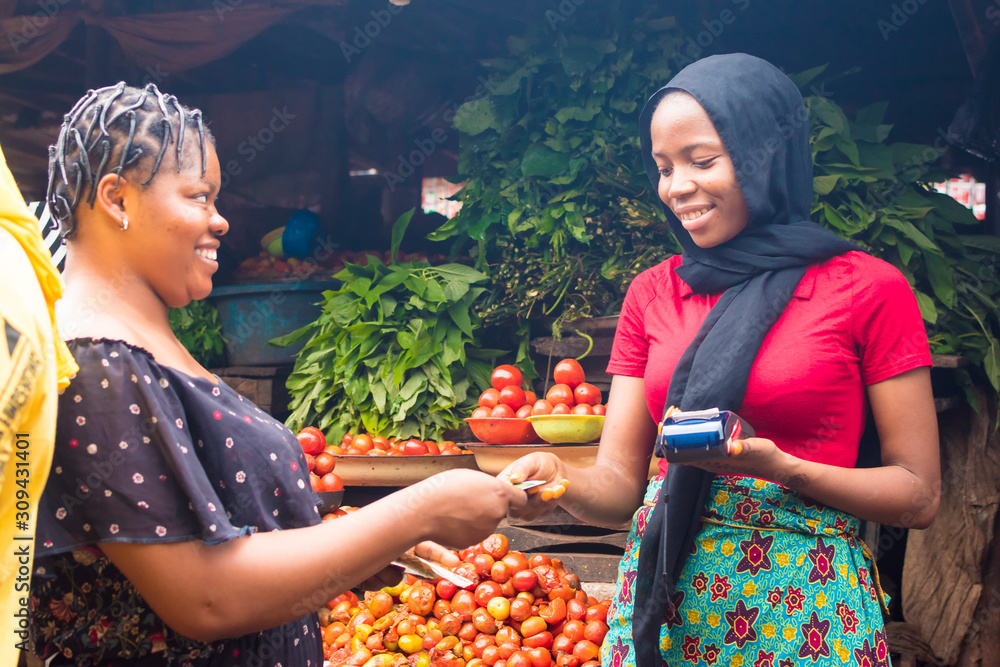 close up of an african woman selling food stuff in a local african ...