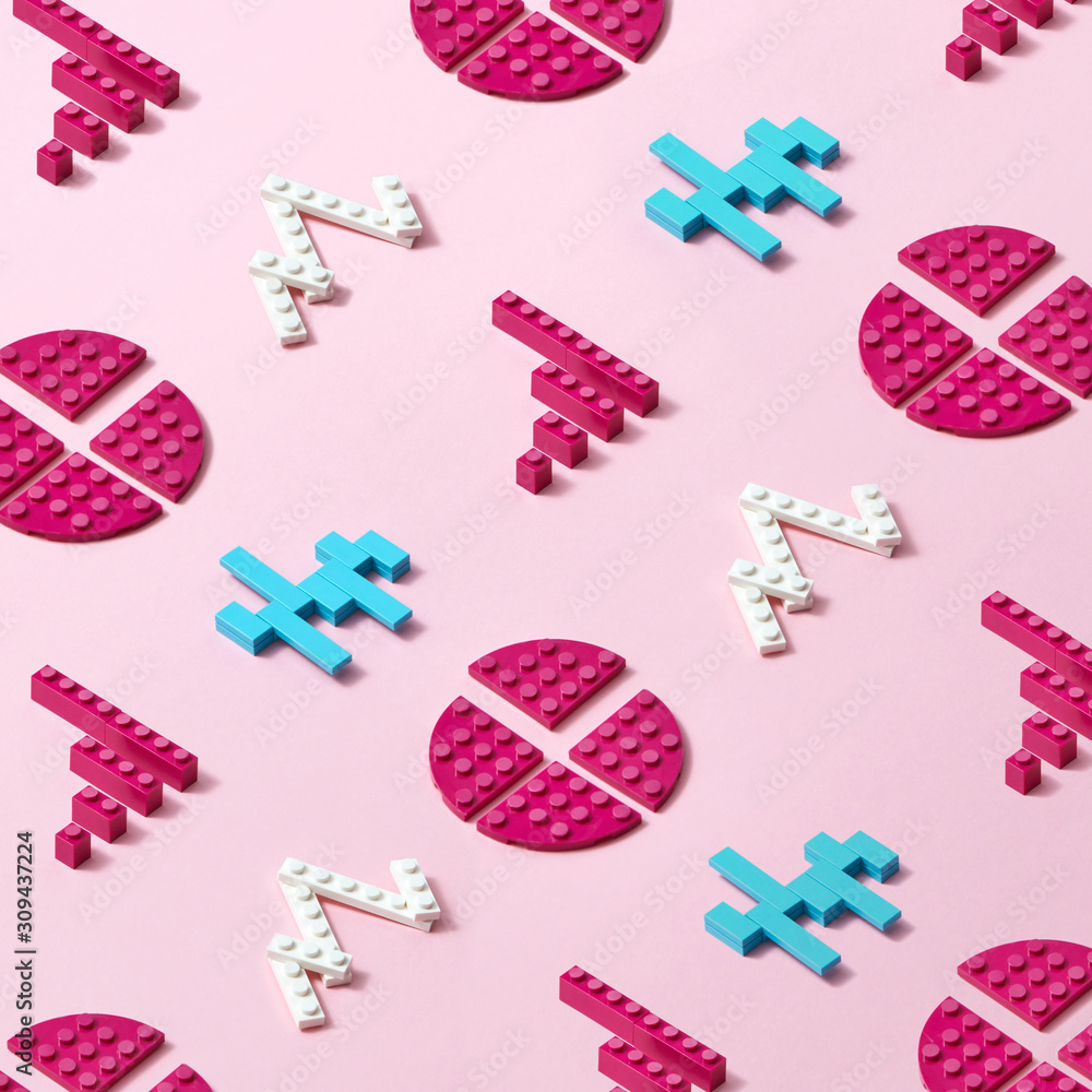 Plastic building blocks pattern on a pink background. Financical ...