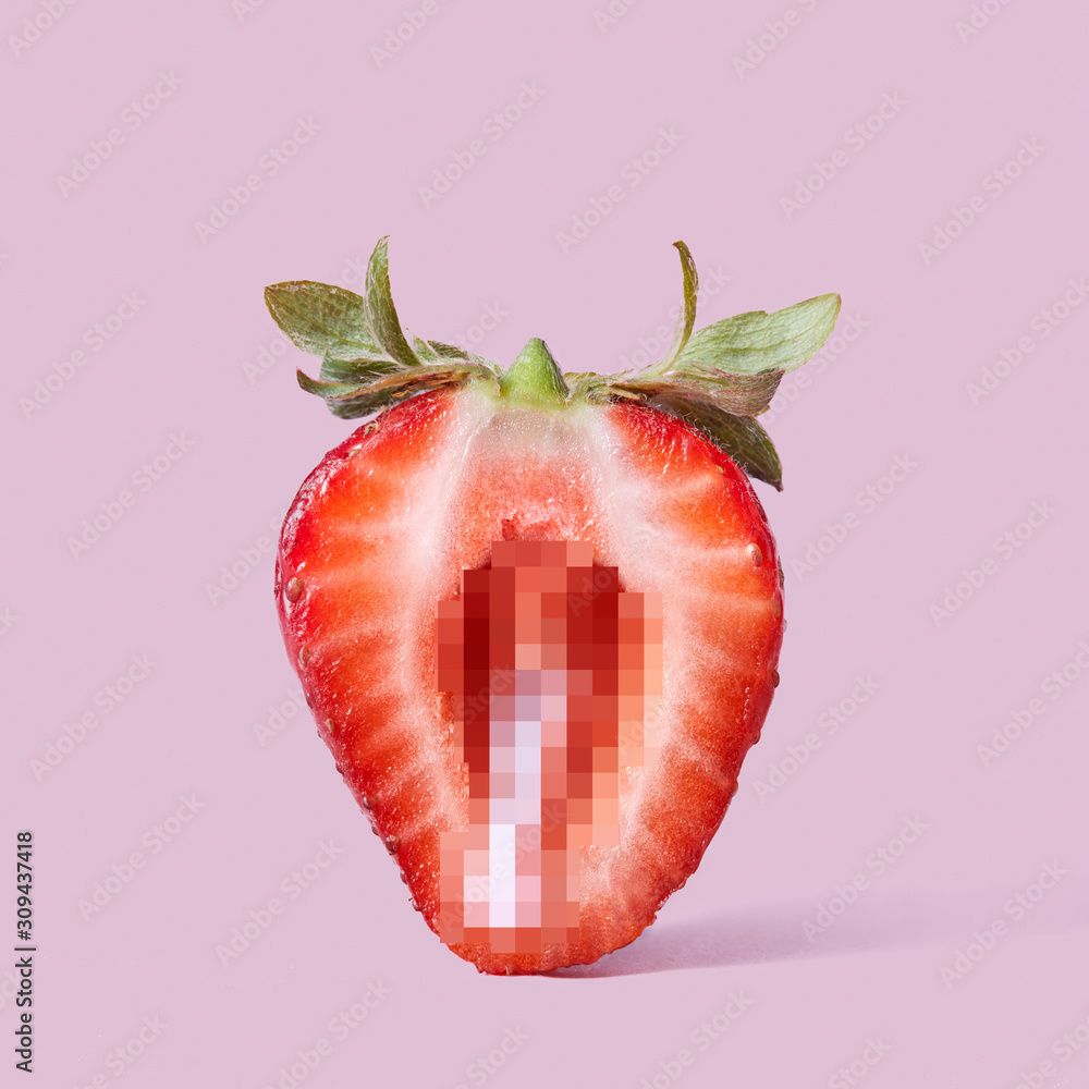 Close Up A Half Of Strawberry With White Liquid Inside On A Pink