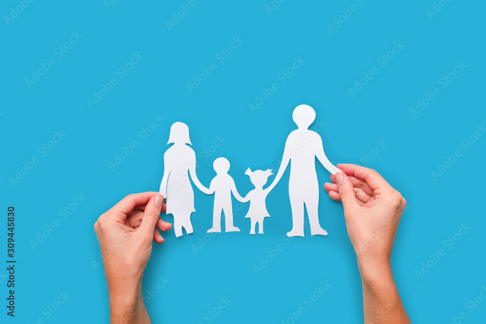 Paper family in hand isolated on blue background Stock Photo | Adobe Stock