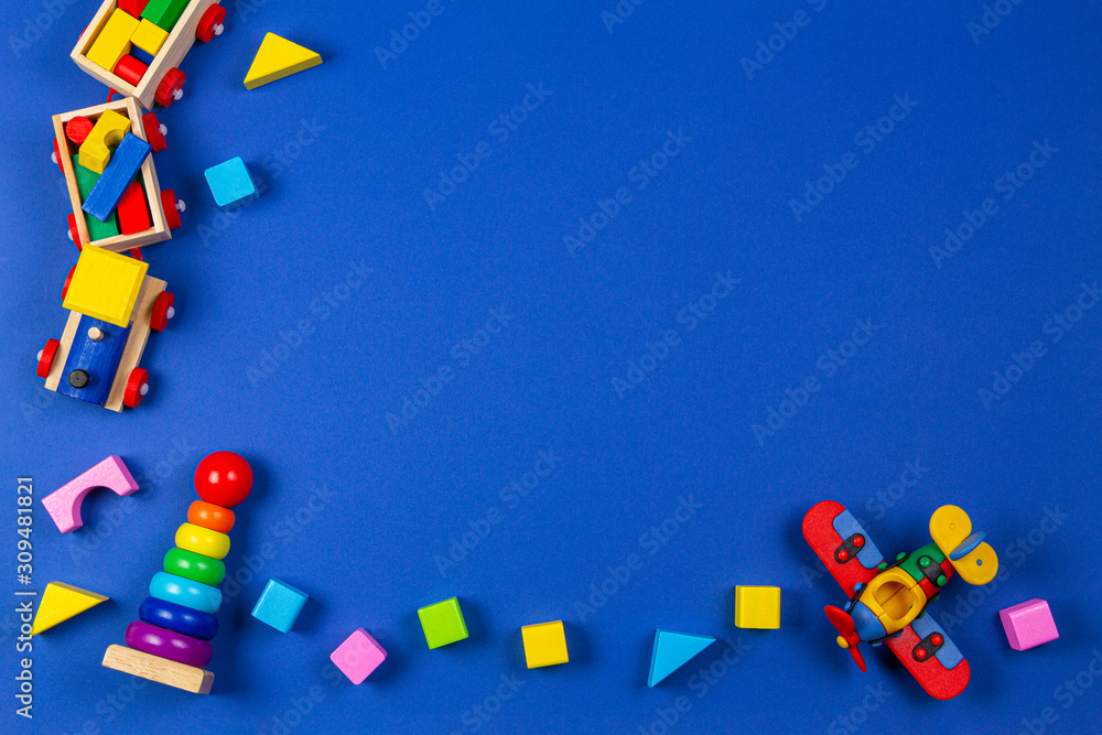 Baby kids toys background. Wooden educational natural toys on navy blue ...