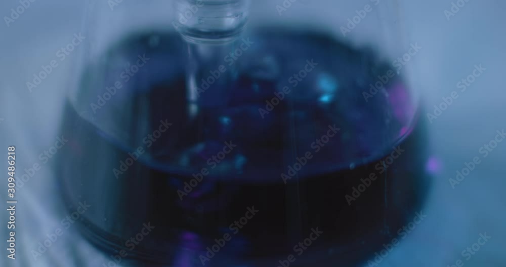 Bubbles coming out of a graduated pipette in a conical flask, during an ...