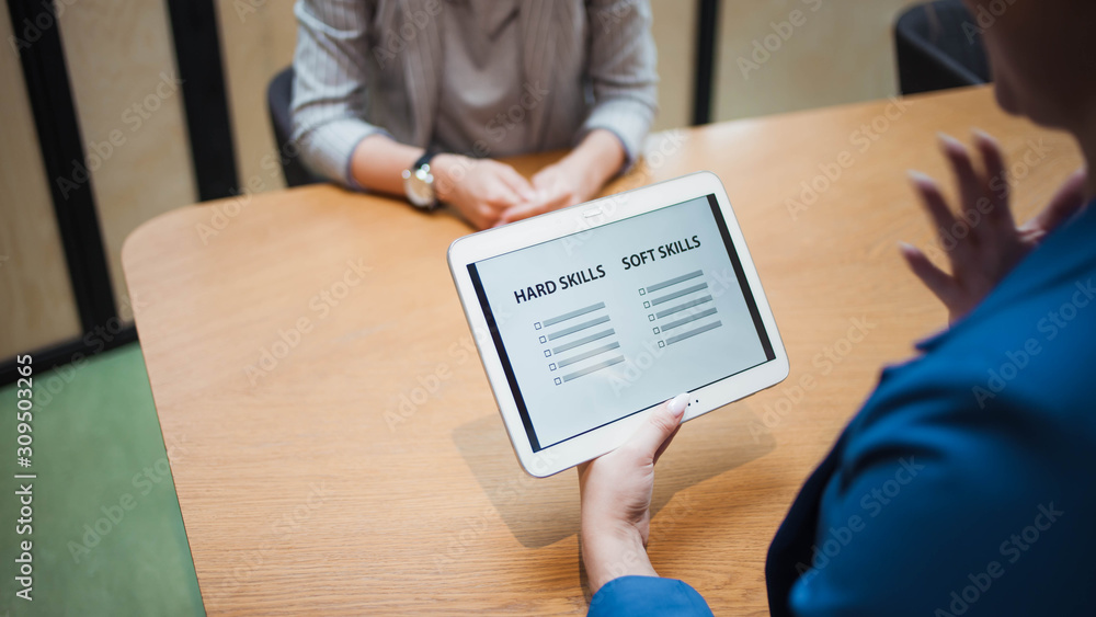 Foto de Job interview. The recruiter holds a tablet with a check list ...