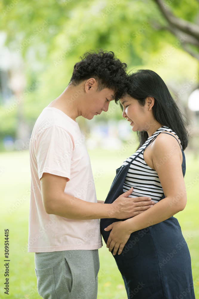 beautiful pregnant woman and her handsome husband hugging the tummy ...