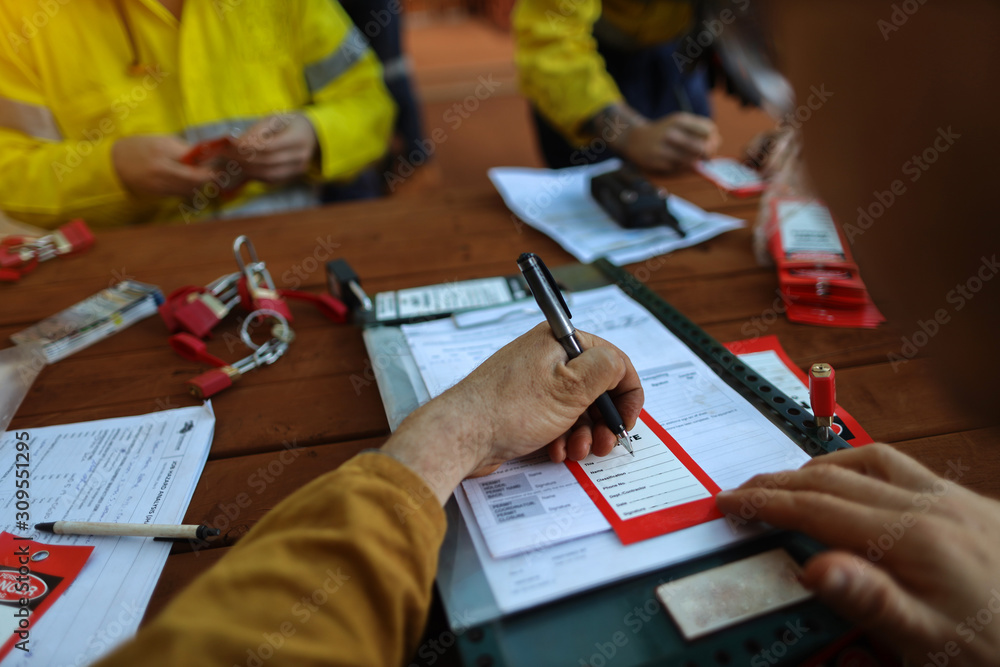 Close up top view of construction worker hand placing personal red ...
