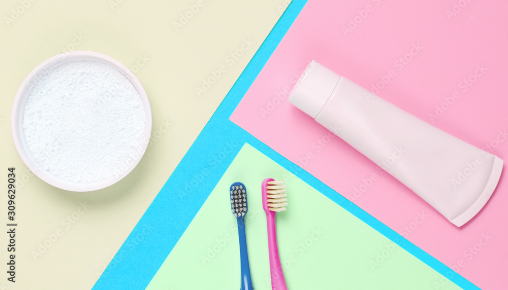 Minimalistic oral hygiene concept. Two toothbrushes with a tube of ...