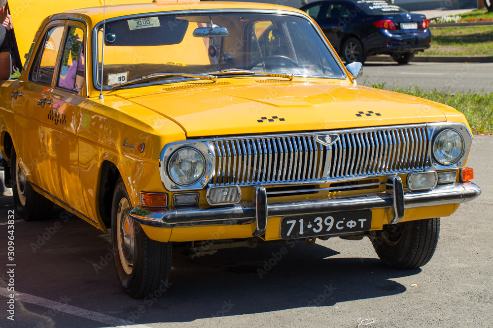 Old Soviet car GAZ-24. Yellow car of Volga brand as a taxi. Russia ...