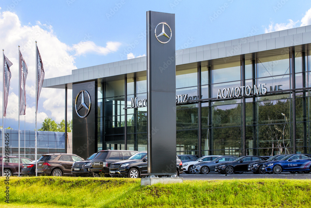 Mercedes-Benz dealership with a modern facade and cars on display in ...