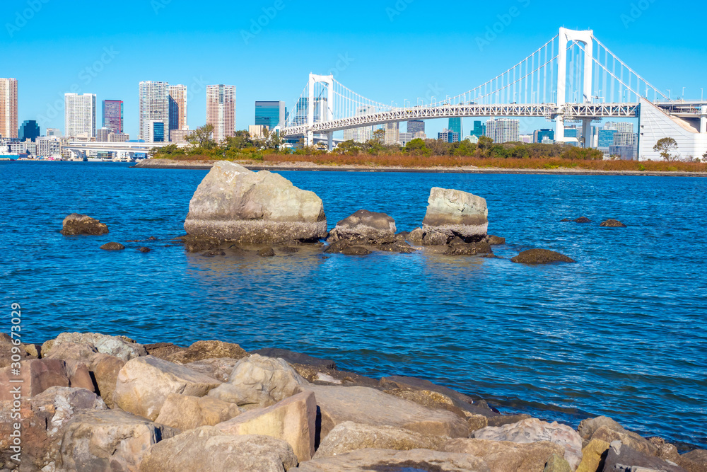 Japan. Tokyo. View of the rainbow bridge from the shore of Tokyo Bay ...