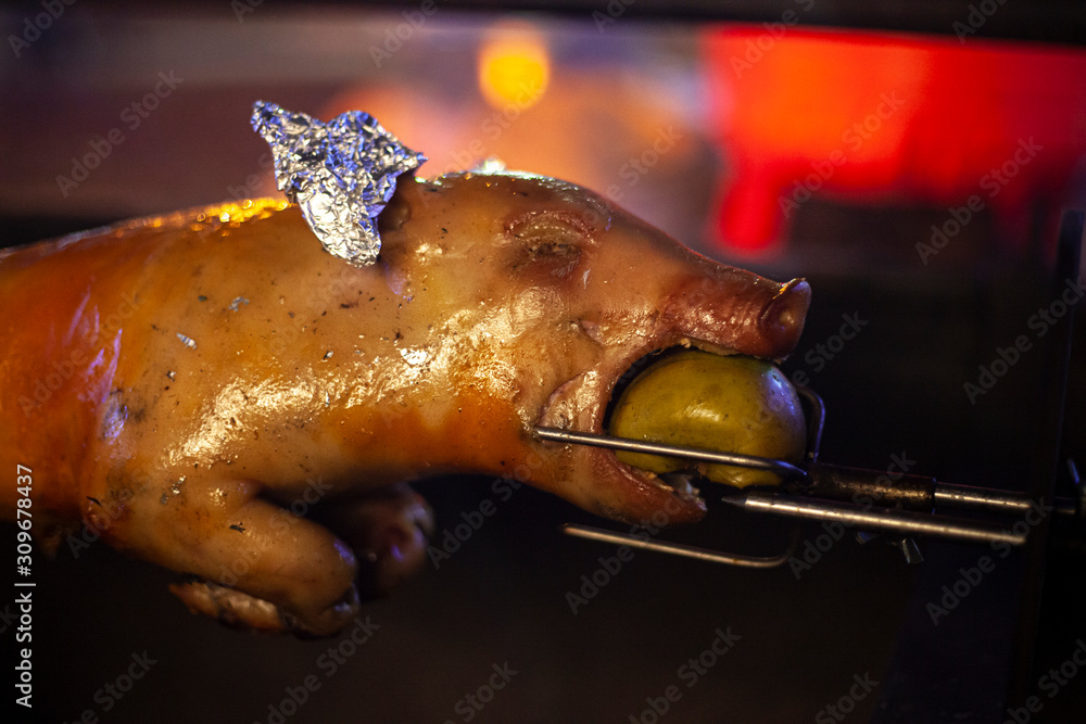 The whole pig is roasted on fire. Golden crust on a toast fried over an ...