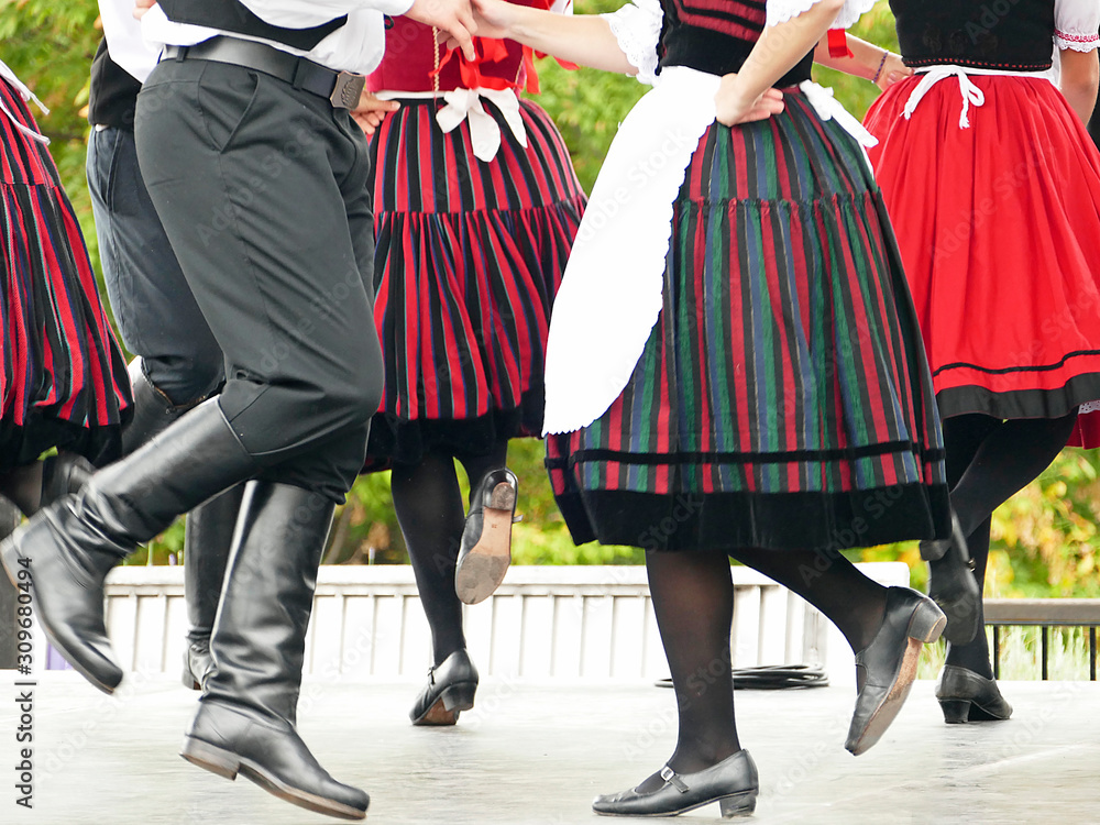 Hungarian folk dancers dancing in black, white and red in a traditional ...