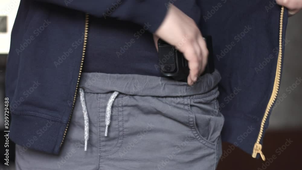 Close up of a young boy revealing a nine millimeter toy gun perfect ...
