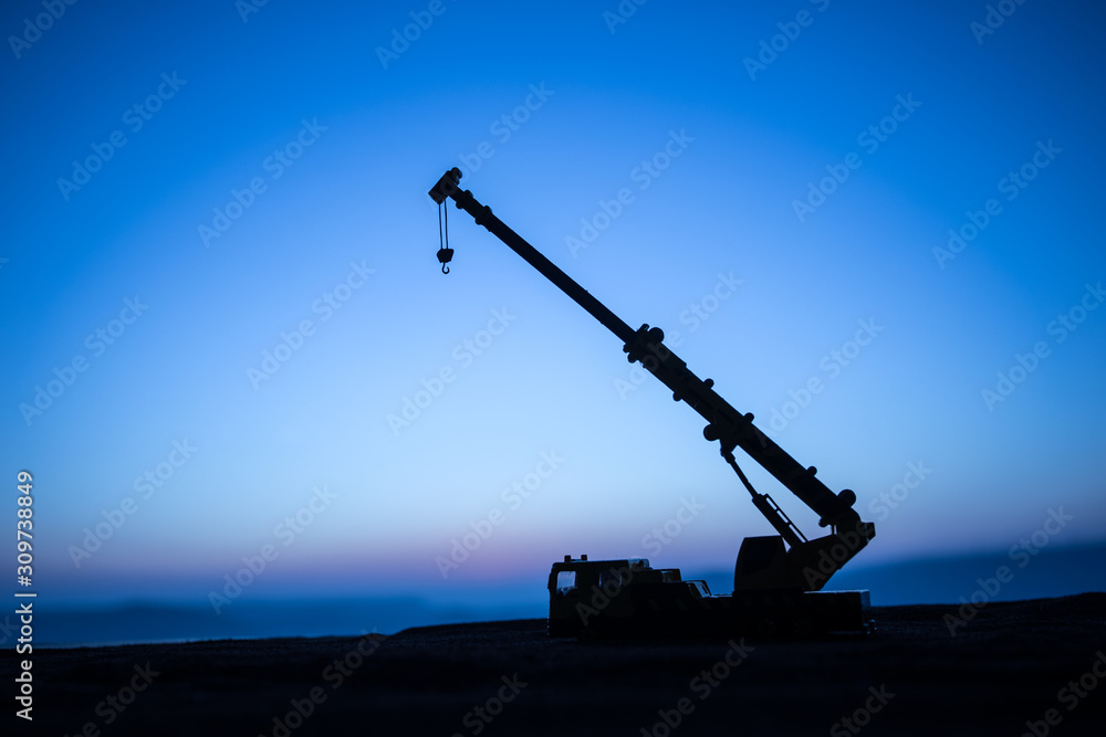 Abstract Industrial background with construction crane silhouette over ...