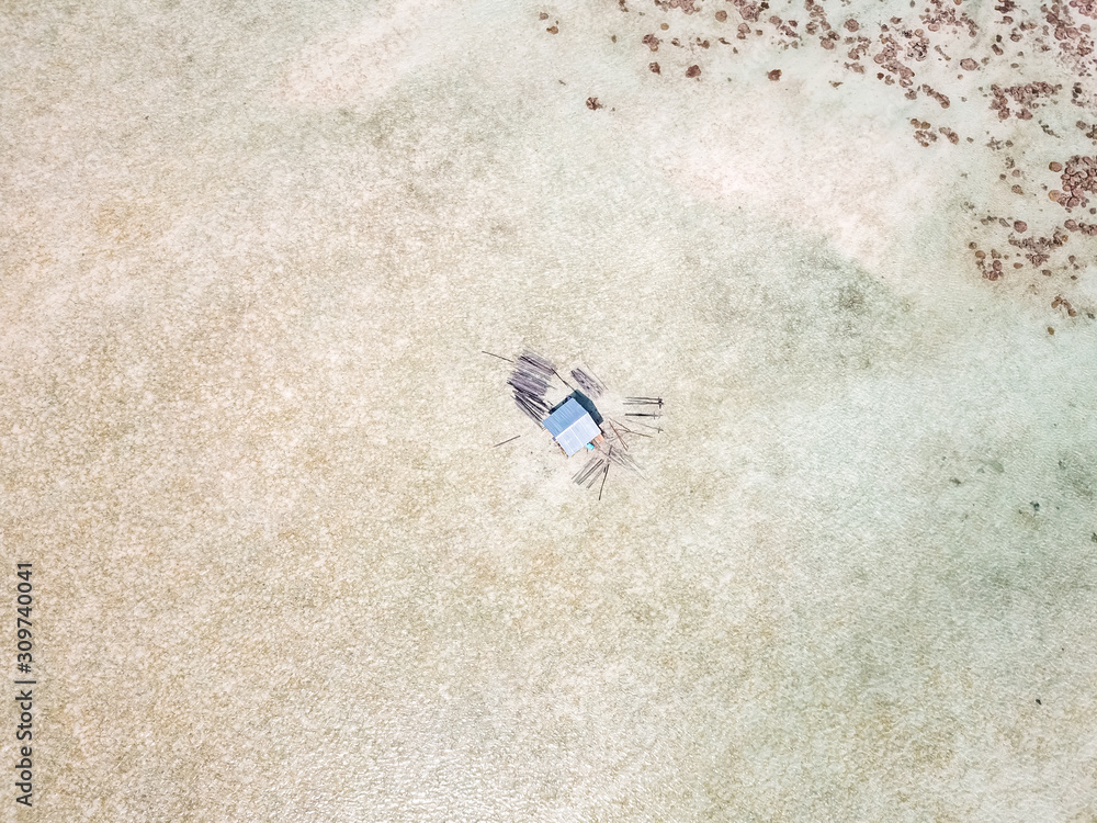 Over water small hut of cage fisherman. Blue azure turquoise lagoon ...