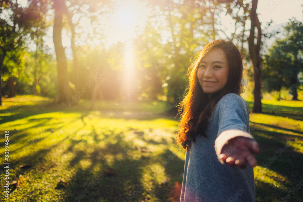 Follow me, a beautiful asian woman holding hands and leads into the ...