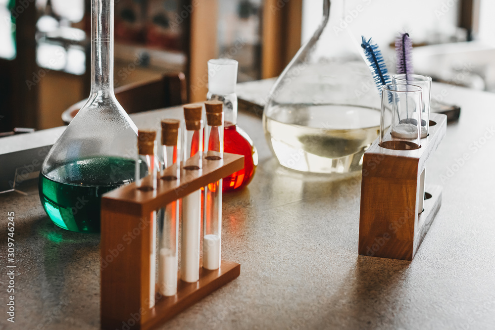 Historic old pharmacy bottles, laboratory beakers on a dark wooden ...