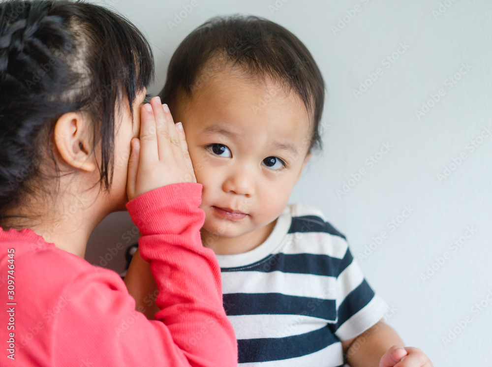 Little sister whisper and telling secret with her baby brother.Toddler ...