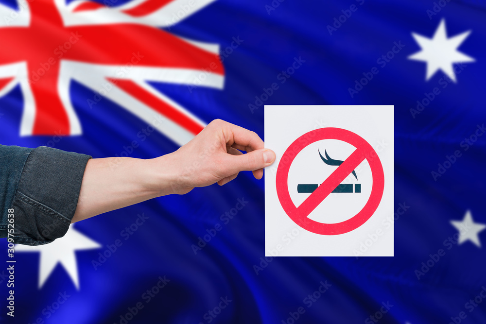 Australia health concept. Hand holding paper with no smoking sign over ...