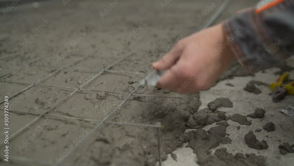 Installation of beacons on the concrete floor. Installation of metal ...