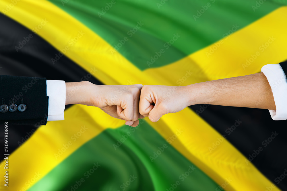 Jamaica agreement concept. Man and woman fist bumping on national flag ...