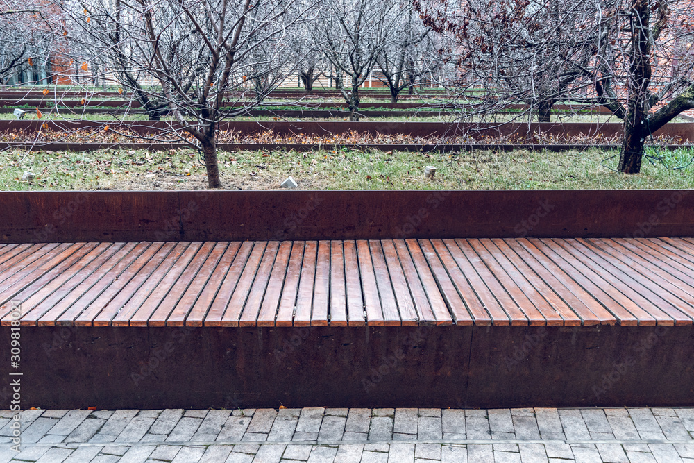 Modern long wooden bench in the park. Design of urban public space. The ...