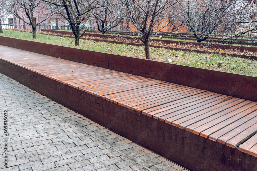 Modern long wooden bench in the park. Design of urban public space. The ...