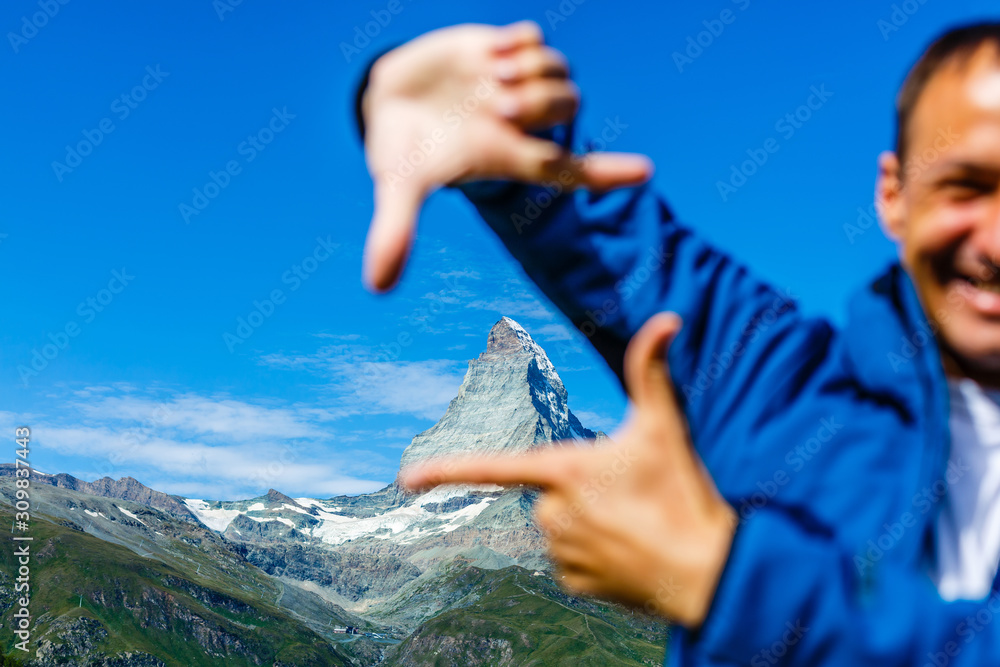 Hiker poses in front of mountain peaks range hiking backpacker old ...