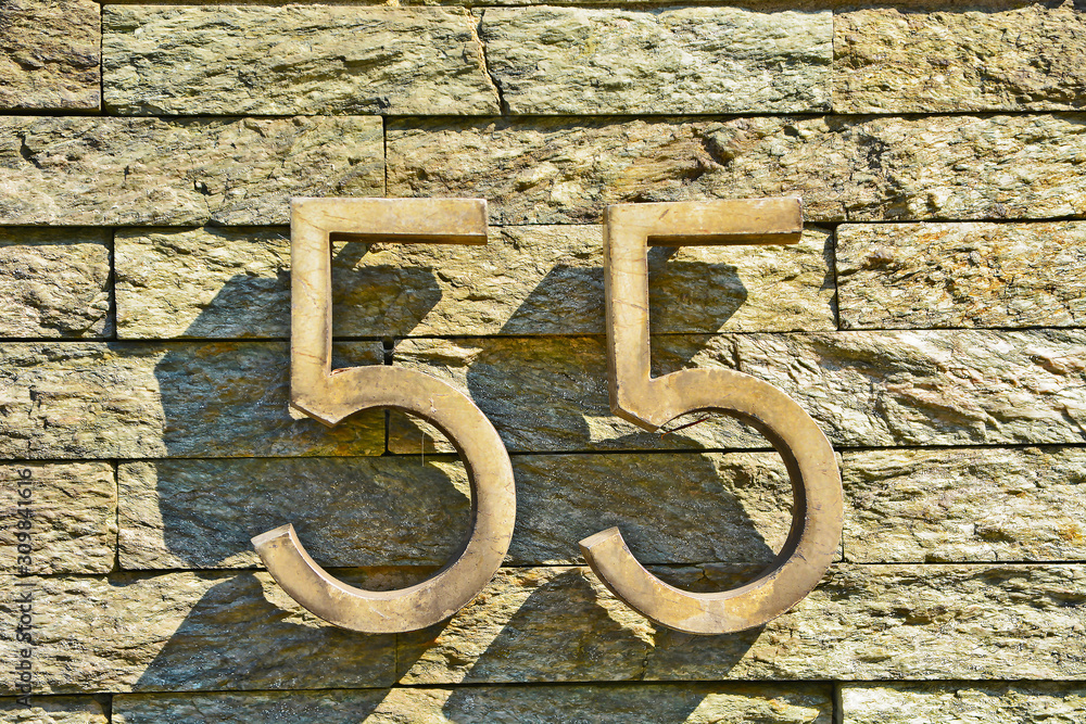 A house number plaque, showing the number fifty five (55) Stock Photo ...