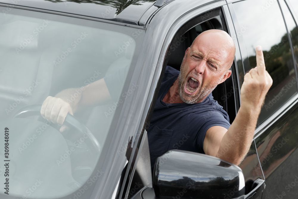 impudent man at the wheel shows an indecent gesture Stock Photo | Adobe ...