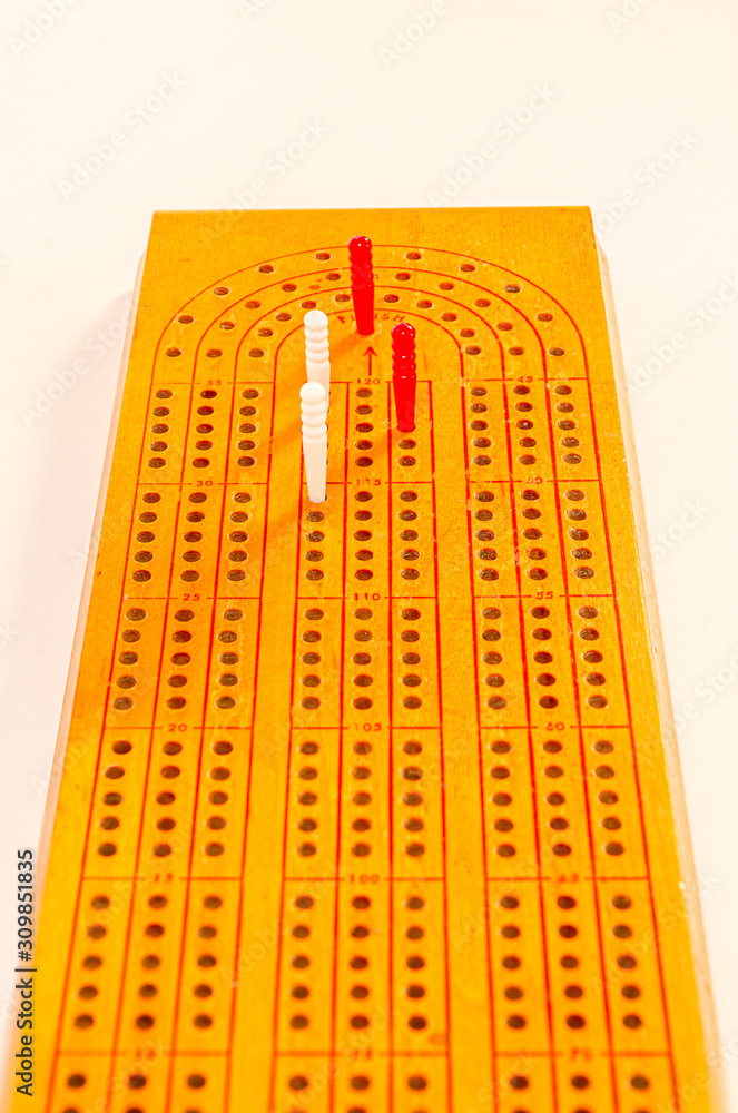 Long view of a cribbage board with pegs Stock Photo | Adobe Stock