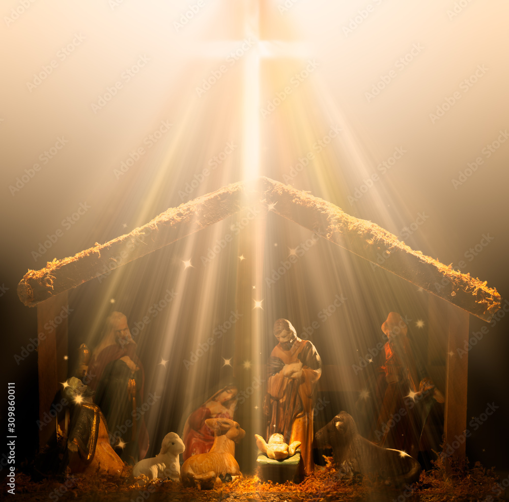 Christian nativity scene glowing in heavenly rays of light with the ...