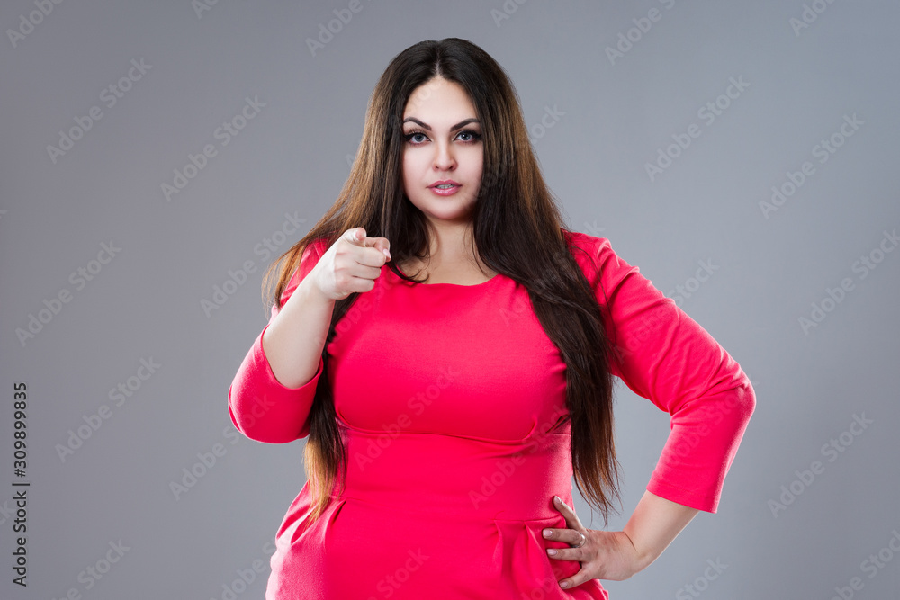 Plus size model in red dress points a finger, fat woman with long hair ...
