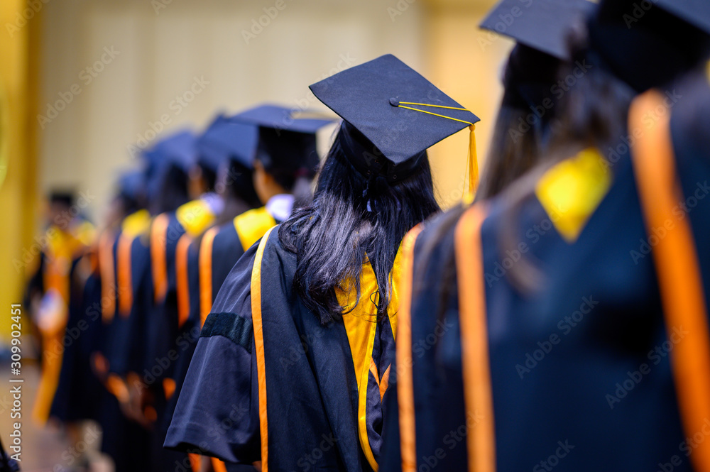 The back of the graduates are walking to attend the graduation ceremony ...