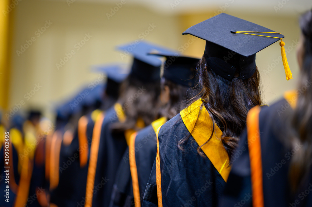 The back of the graduates are walking to attend the graduation ceremony ...