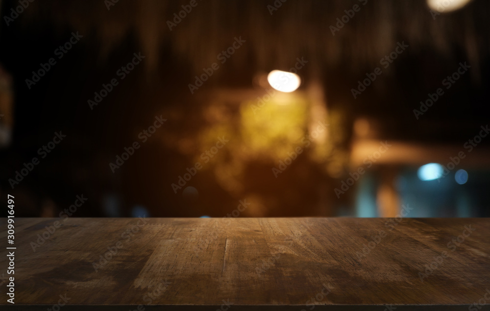 Empty dark wooden table in front of abstract blurred bokeh background ...