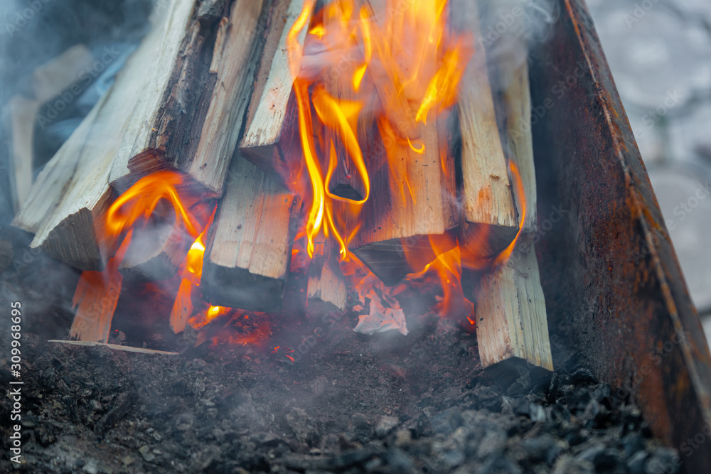 Burning logs for kindling a fire, flame and smoke on fire. Logs in a ...