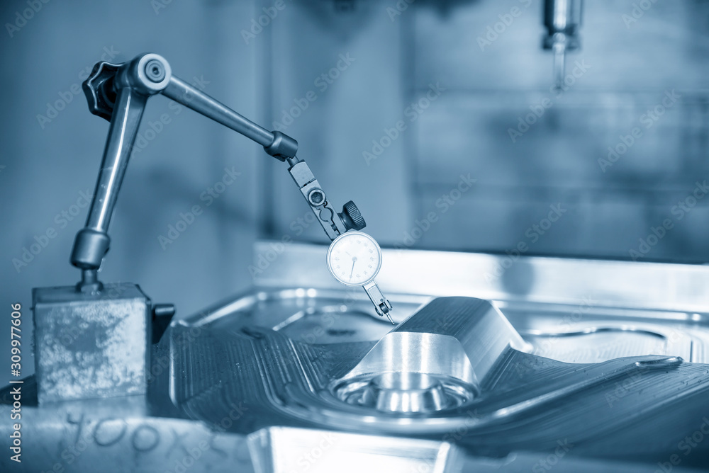 The dial gauge setting on the injection mold parts between the CNC ...