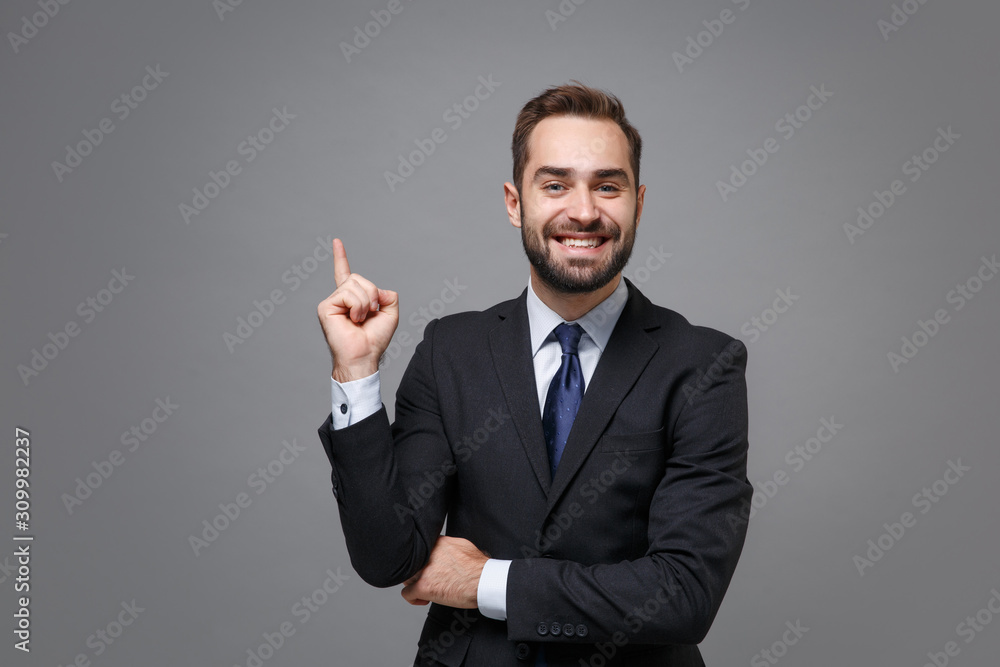 Smiling young bearded business man in classic black suit shirt tie ...