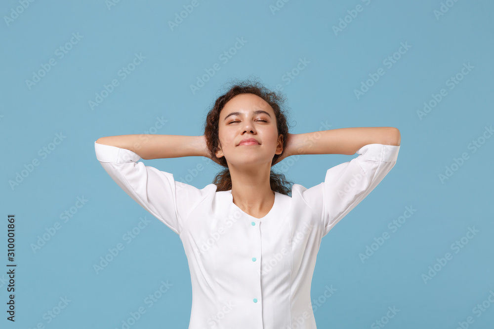 African american doctor woman isolated on blue background in studio ...