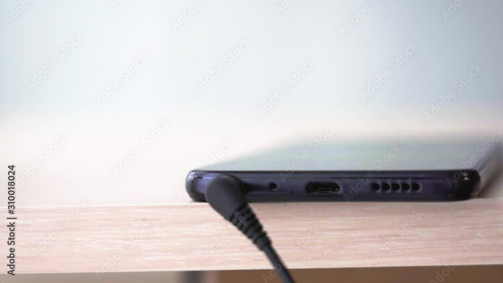Insert and pull out the plug of the audio jack smartphone. Connecting ...